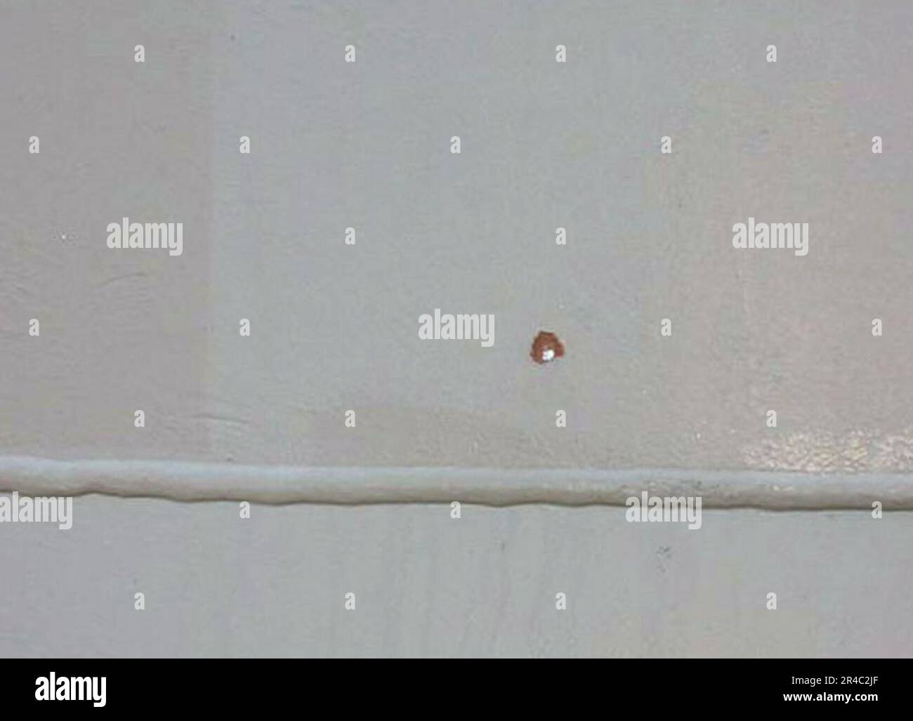 US Navy Evidence of small arms fire impact is visible on USS Cape St ...