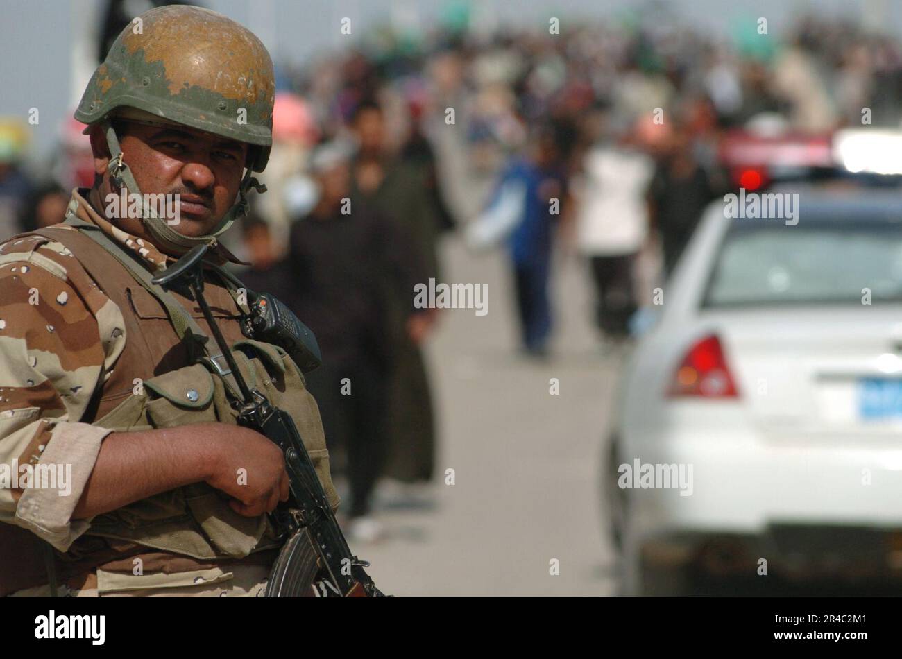 US Navy An Iraqi Army soldier stands guard at a checkpoint as he ...