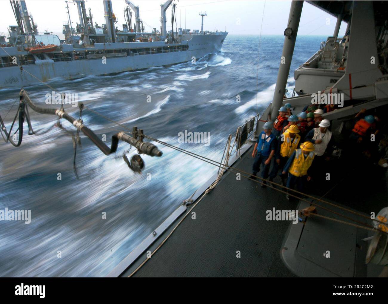 US Navy Amphibious command ship USS Blue Ridge (LCC 19) Sailors look on ...