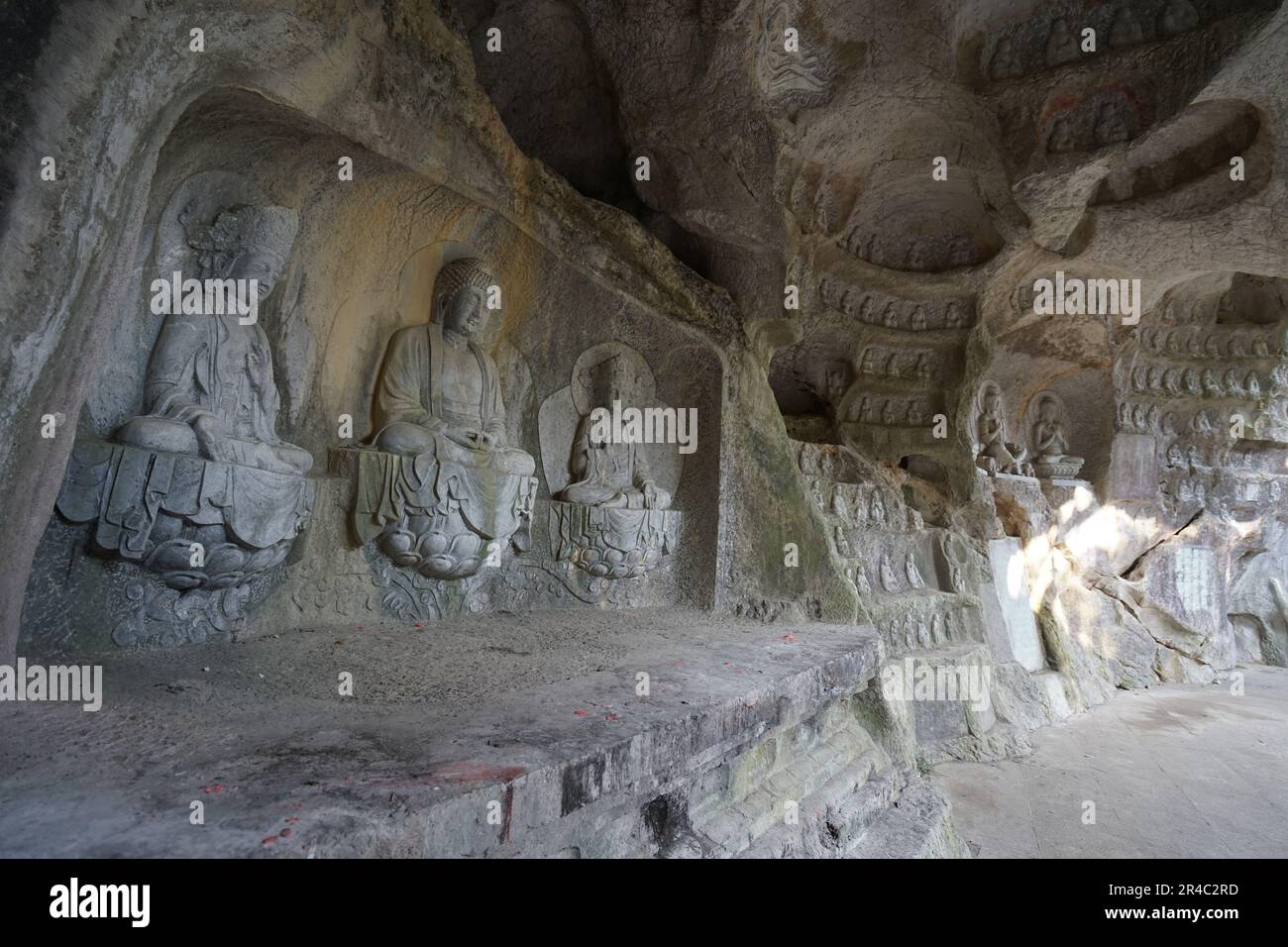 This image features an underground cave with intricately carved walls ...