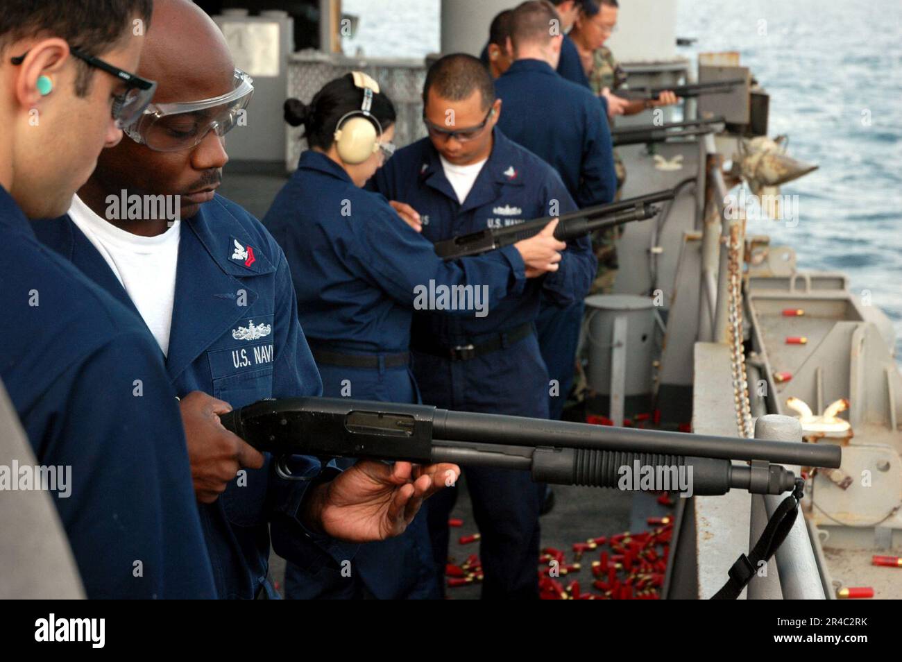 US Navy Sailors are instructed in the proper handling and use of a 12 ...