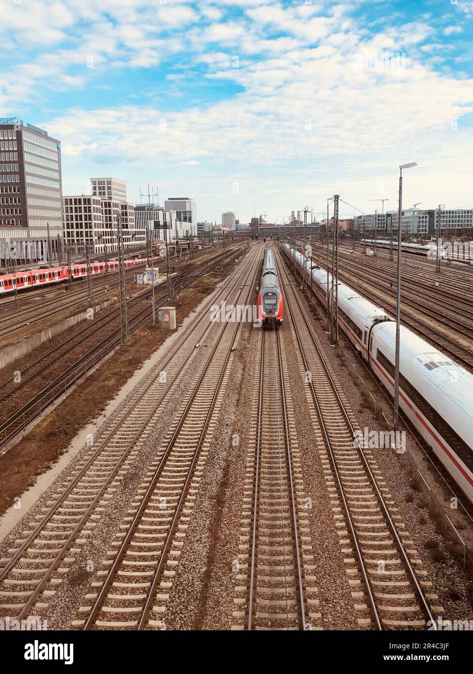 An aerial view of an industrial train yard featuring long, empty tracks ...