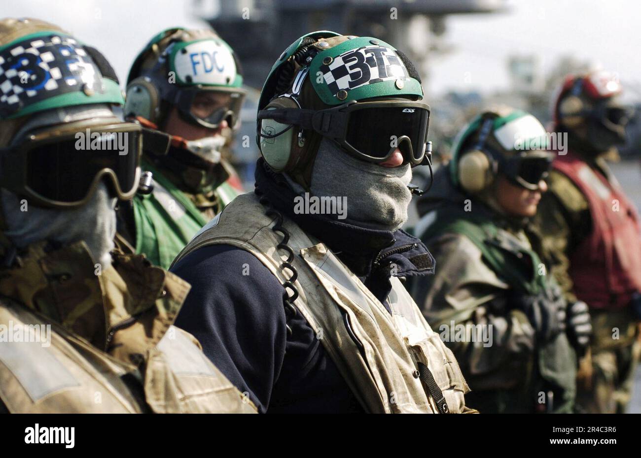 US Navy Sailor's seeking warmth by wearing their flash gear watch as an ...