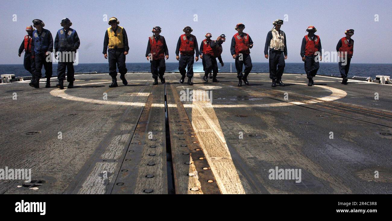 US Navy Sailors perform a foreign object debris (FOD) walk down in the ...