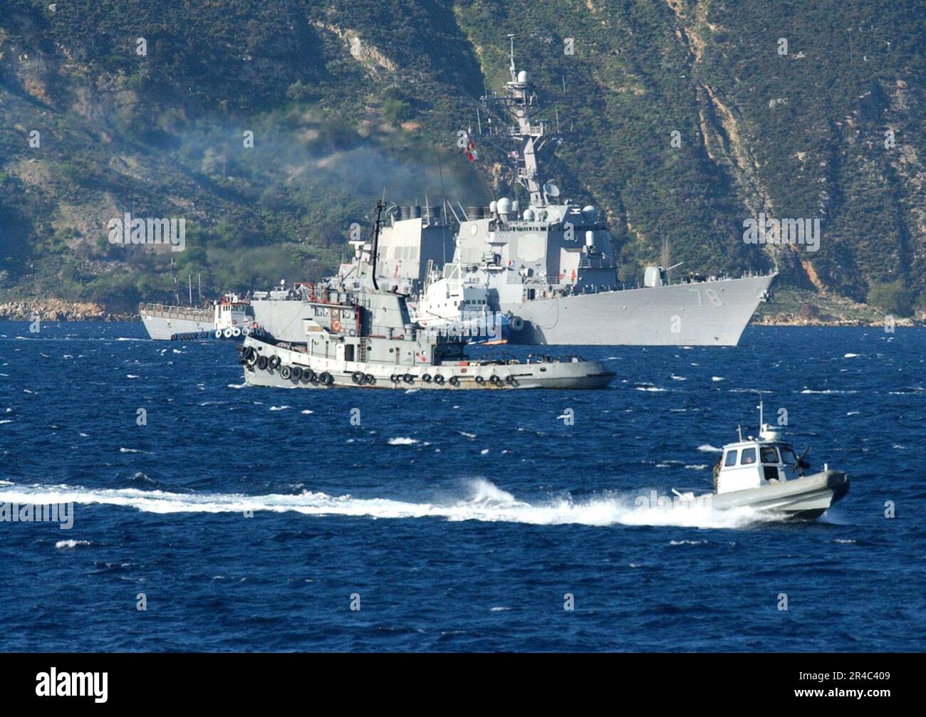 US Navy A harbor security boat patrols the area as the guided missile ...