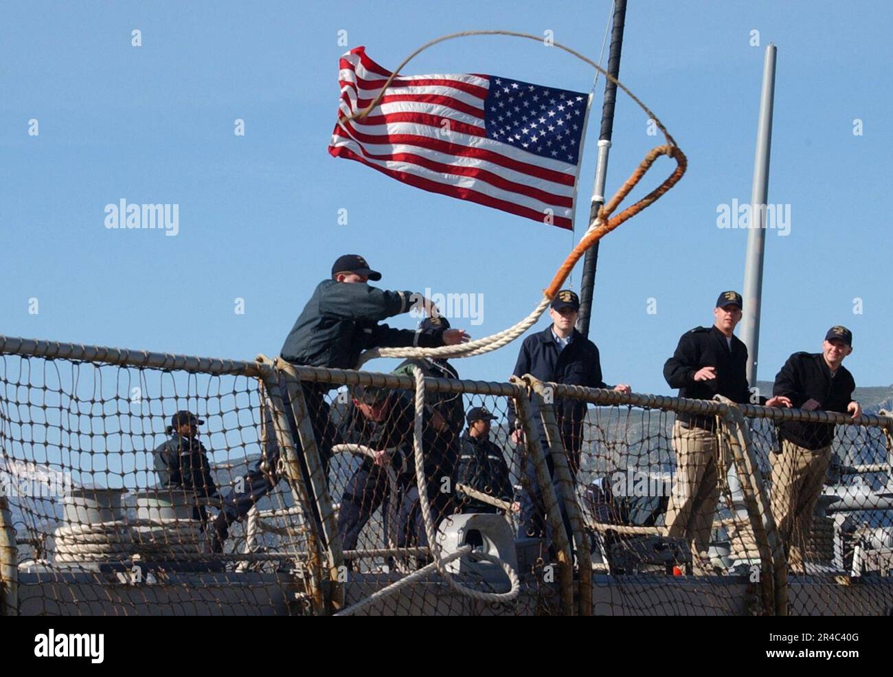 US Navy A Sailor heaves a mooring line ashore as the guided missile ...