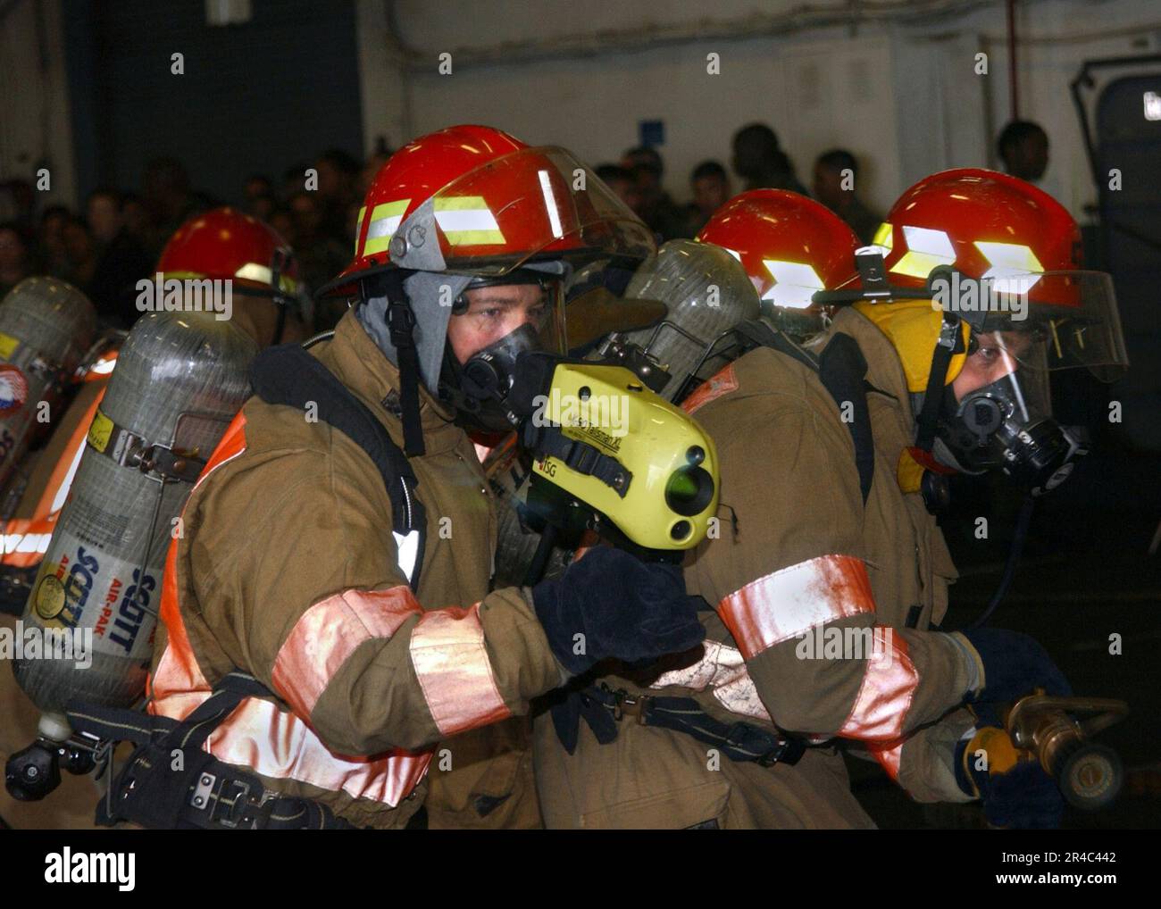 US Navy Fire fighters aboard the amphibious assault ship USS Tarawa ...