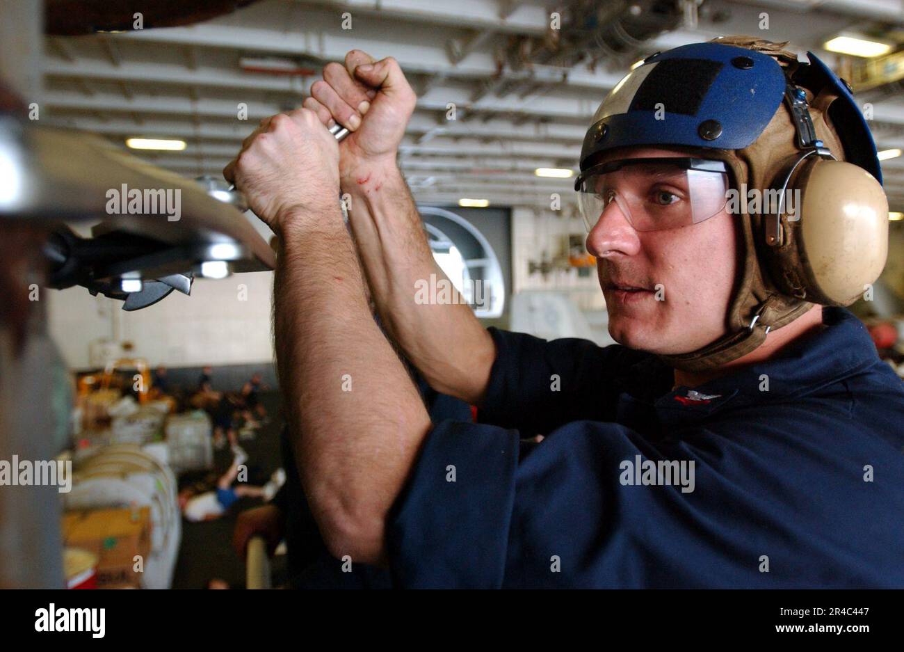 US Navy Machinery Repairman 2nd Class performs maintenance on a deck ...