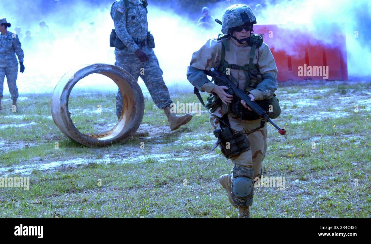 US Navy A Navy Reservist rushes through a simulated battlefield during ...