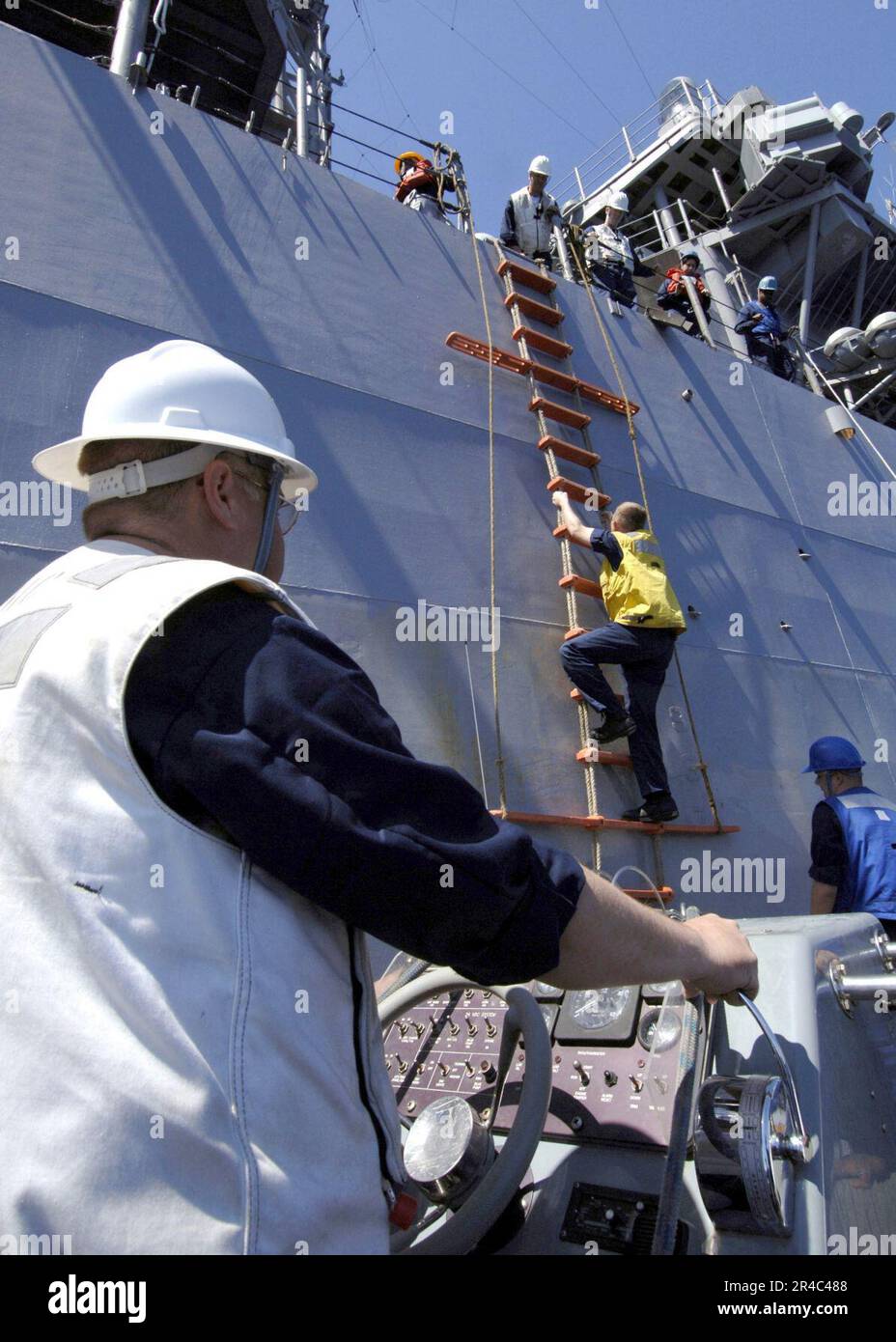 US Navy hief Boatswain's Mate watches crew members depart a Rigid Hull ...