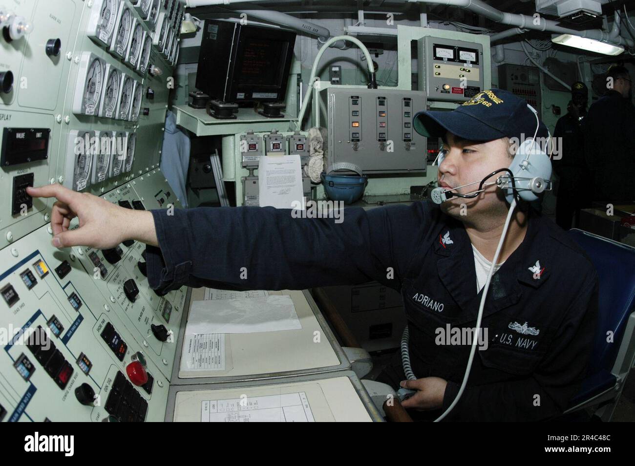 US Navy Electrician's Mate 3rd Class adjusts the voltage and frequency ...