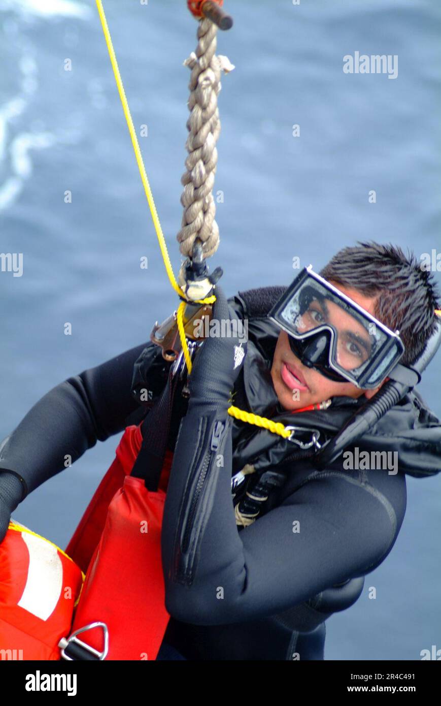 US Navy Search and rescue (SAR) swimmer, is hauled aboard the ...