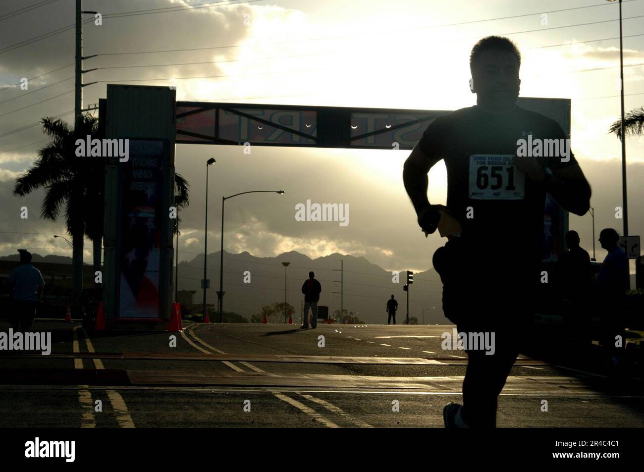US Navy A runner takes off from the starting line of the 2006 Ford ...