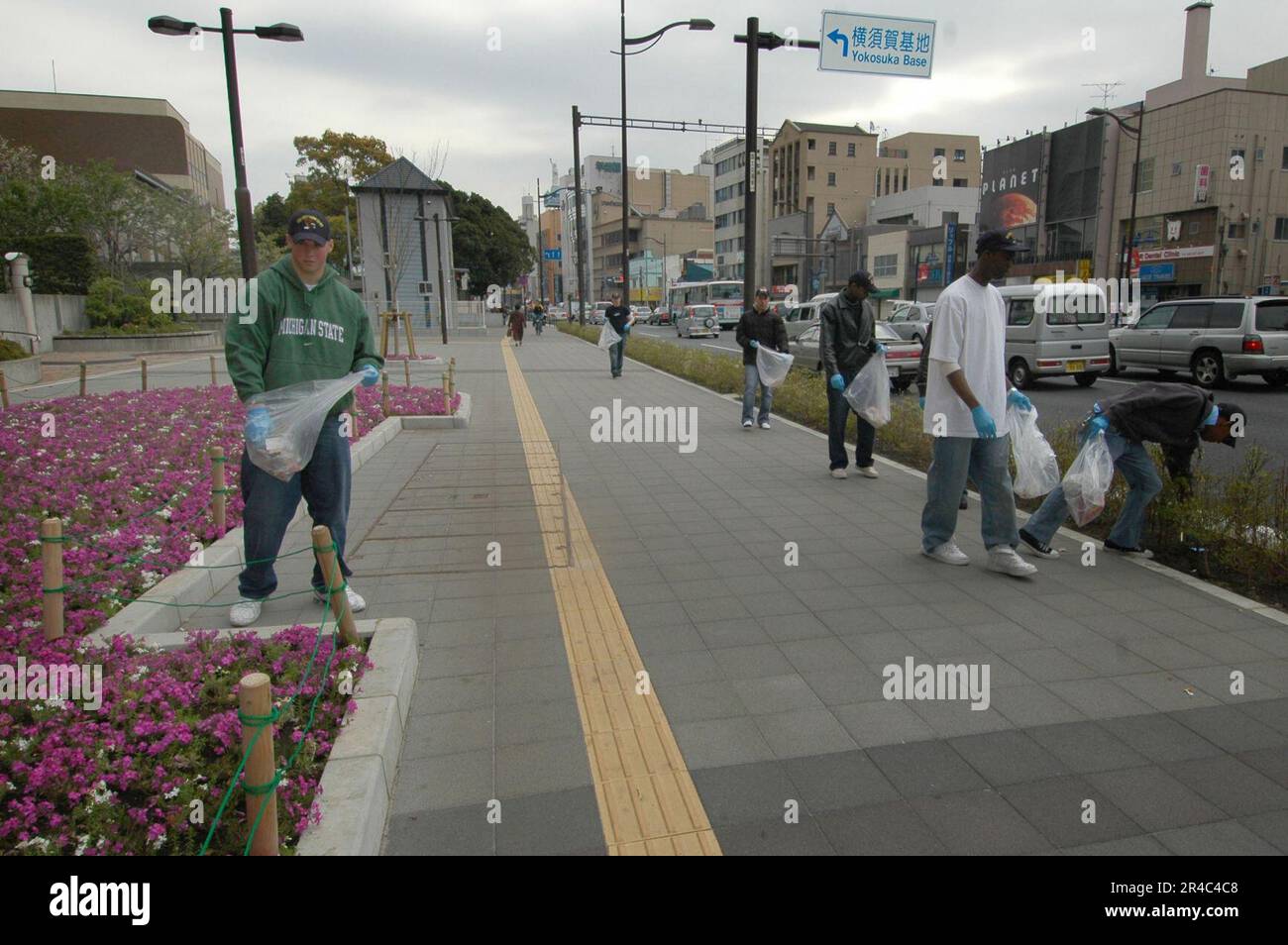 US Navy Sailors assigned to USS Kitty Hawk (CV 63) pick up trash on the ...