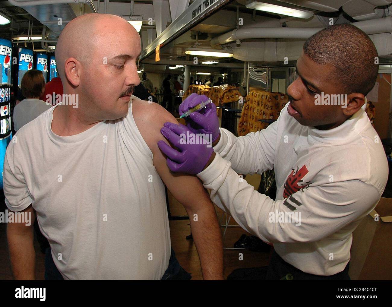US Navy Hospital Corpsman 2nd Class administers a tetanus shot to A ...