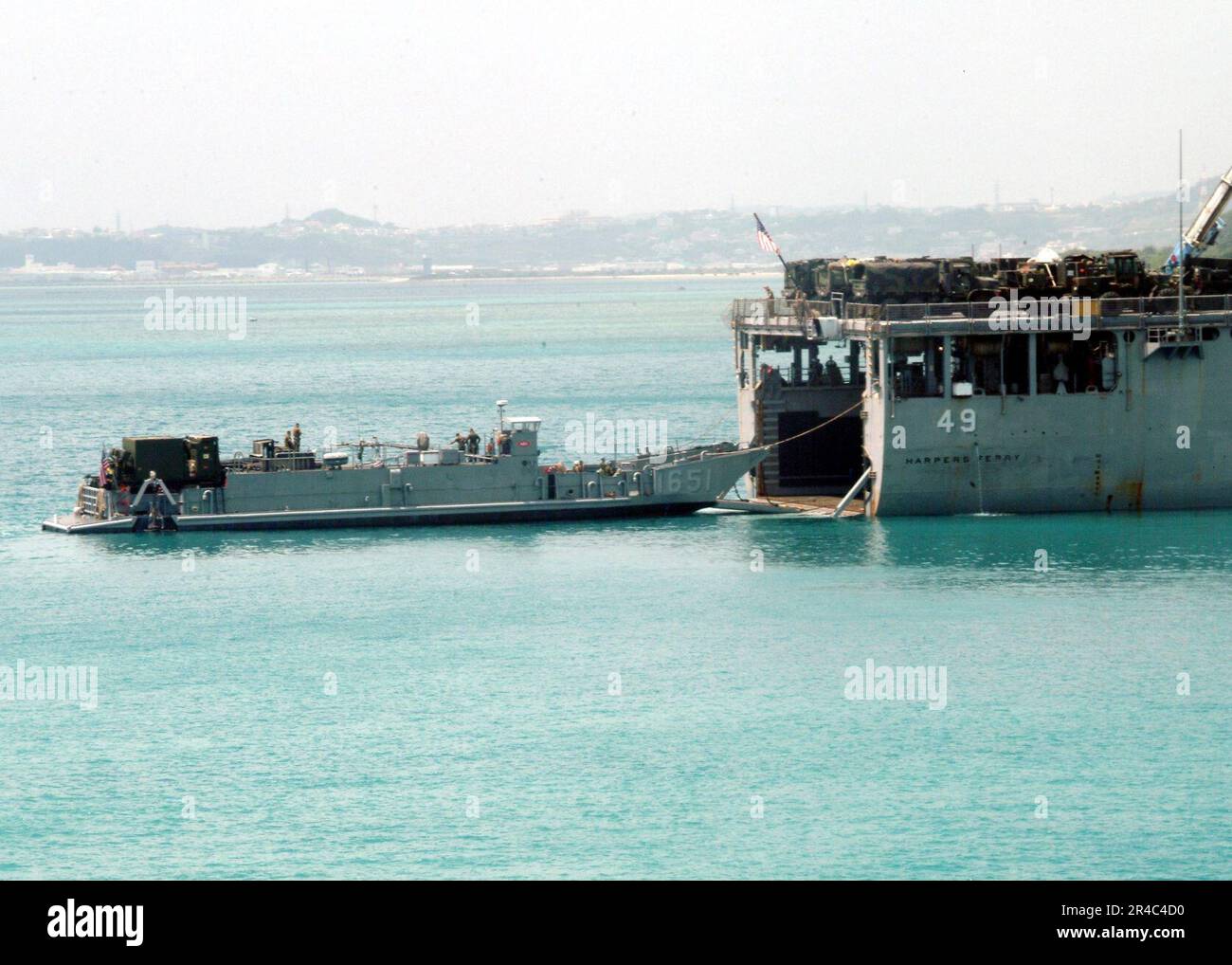 US Navy Landing Craft Utility (LCU) 1651 performs a stern gate marriage ...