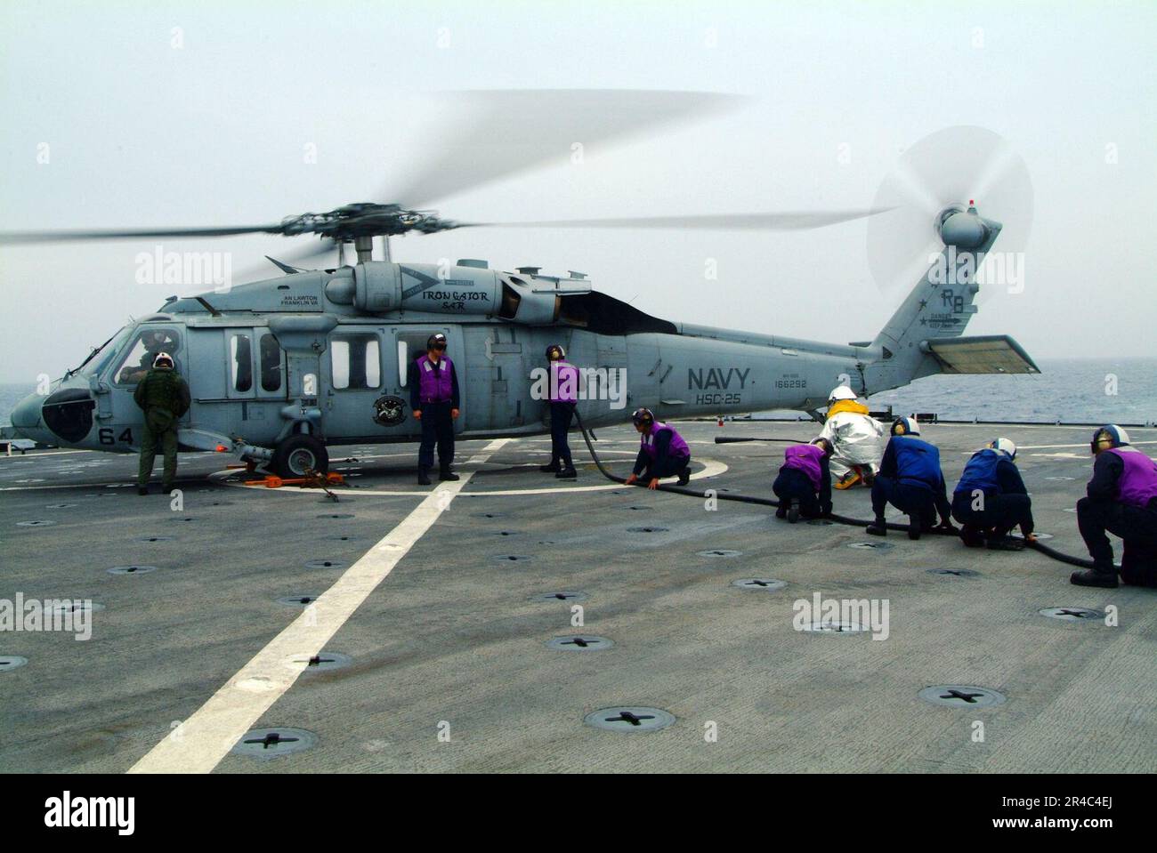 US Navy A refueling crew refuels an MH-60S Seahawk helicopter on the ...