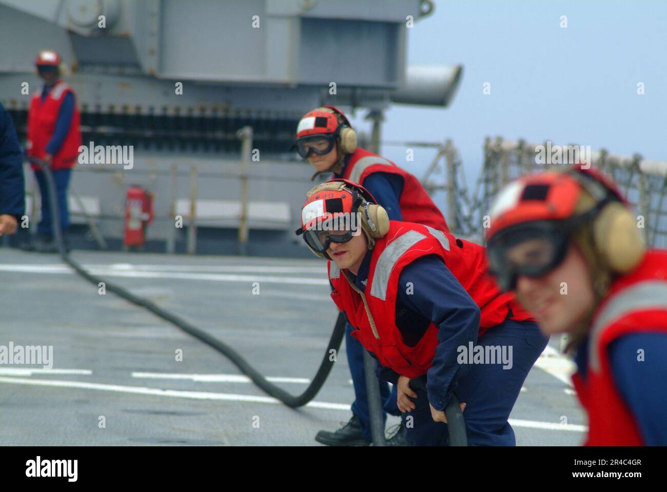 US Navy Hull Maintenance Technician 3rd Class mans an Aqueous Film ...