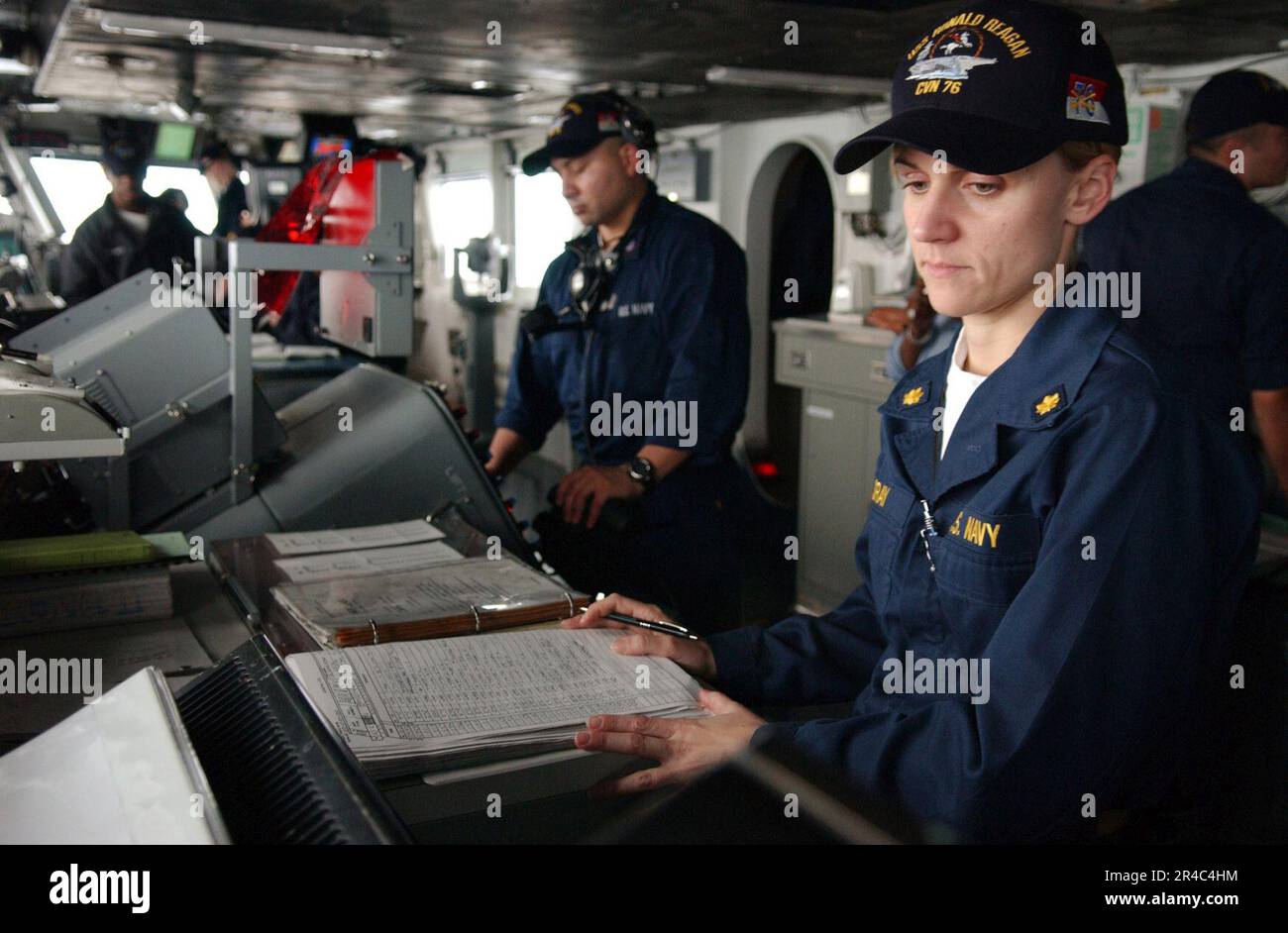 US Navy Lt. Cmdr. watches a tracking monitor while standing the junior ...
