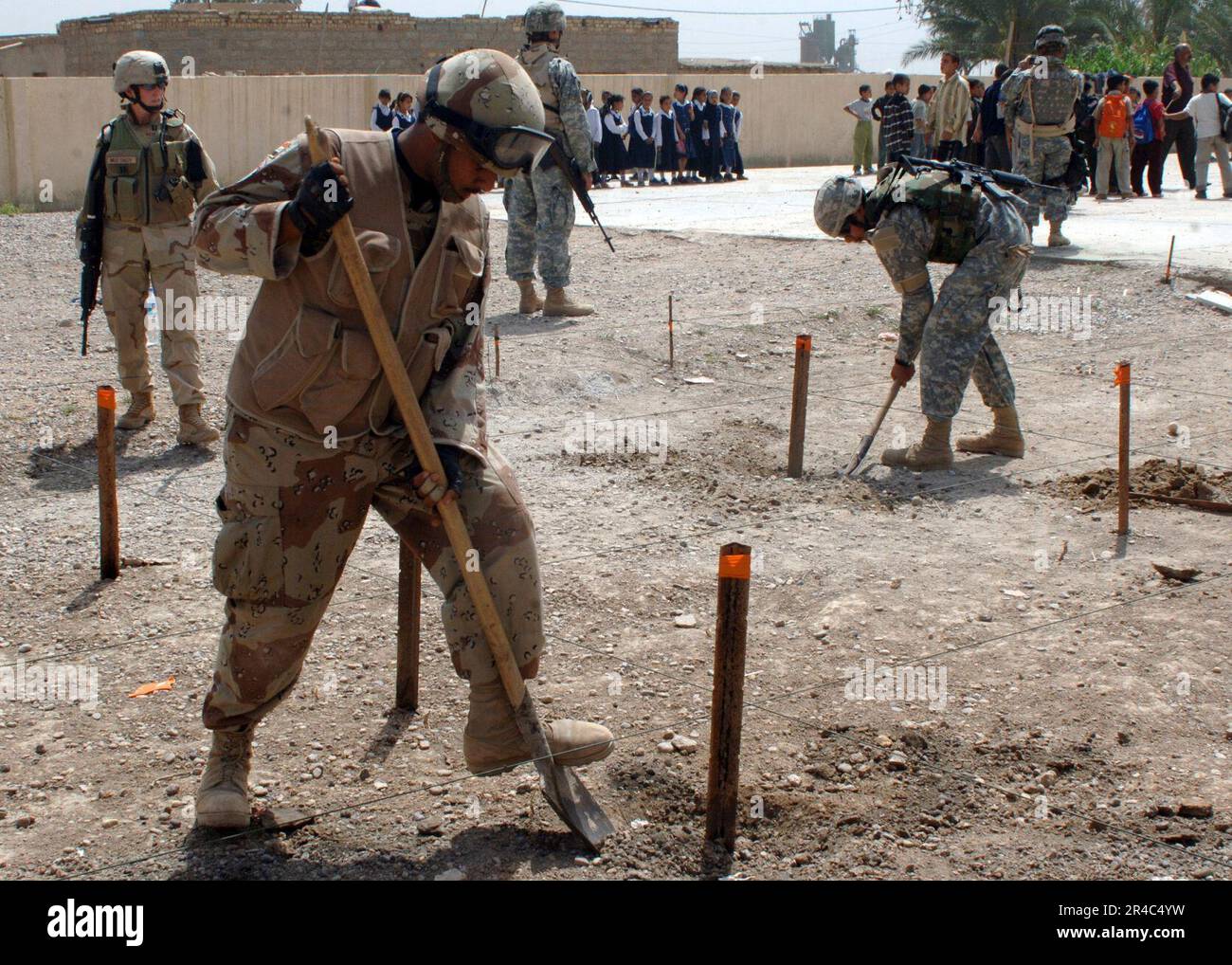 US Navy Iraqi and U.S. Army soldiers construct the framework for a ...