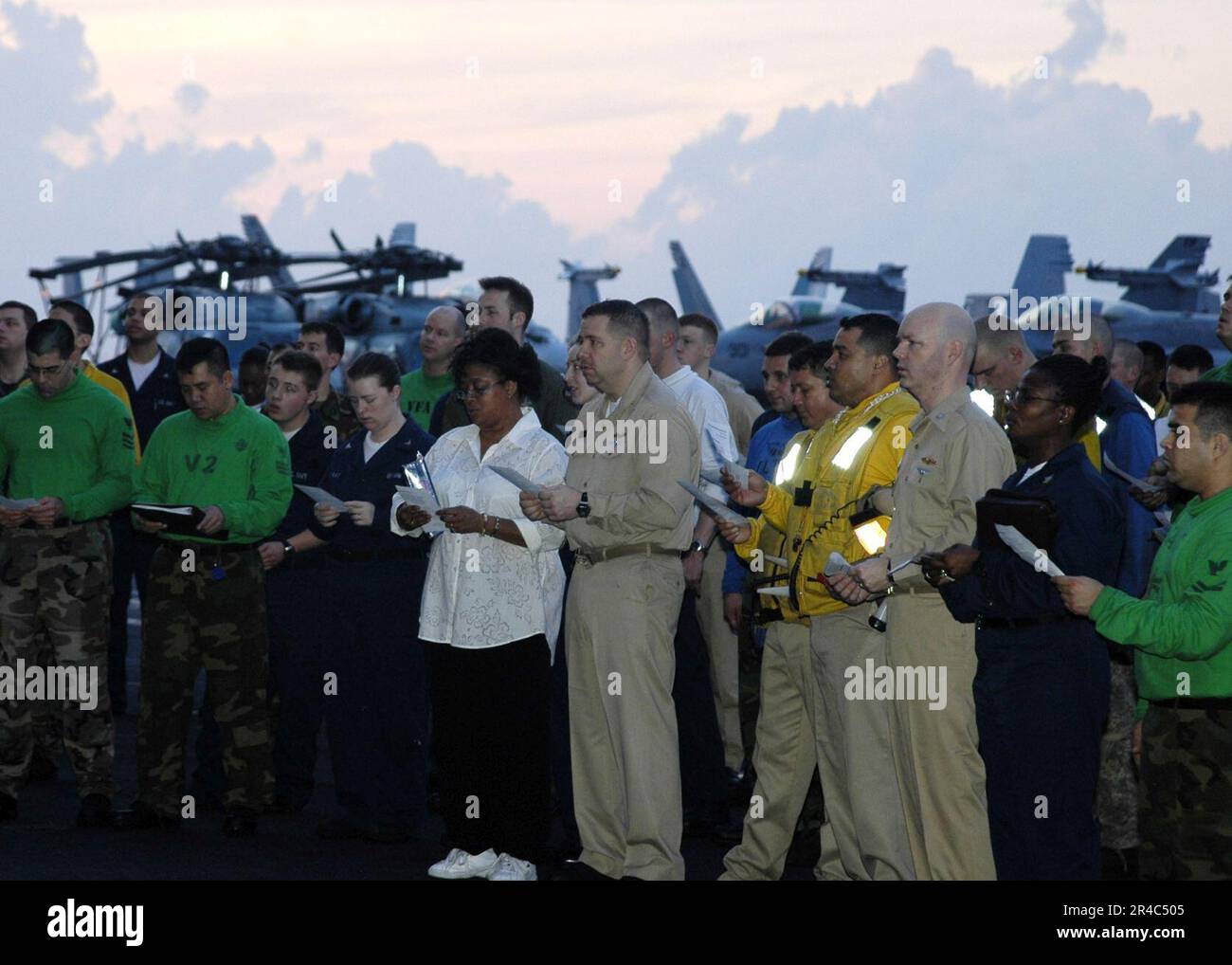 US Navy Sailors and distinguished visitors take part in an Easter ...