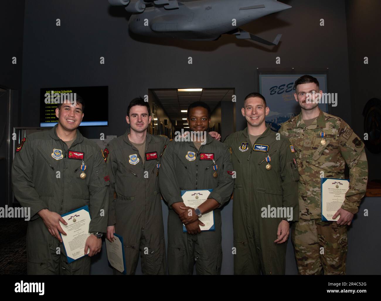 U.S. Airmen gather for a group photo holding their Air Medal citations ...
