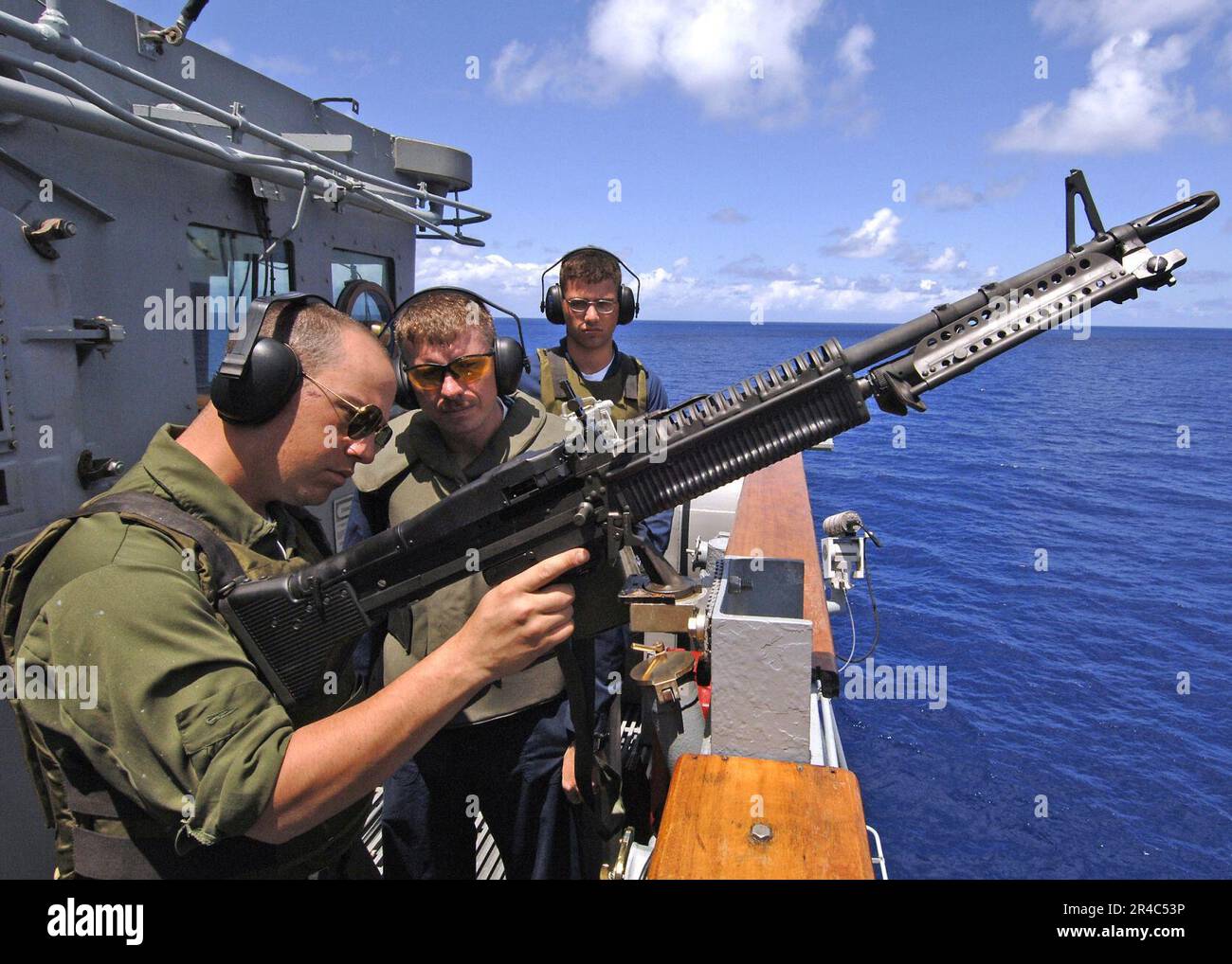 US Navy Seaman left, receives instruction on firing an M-60 machine gun ...