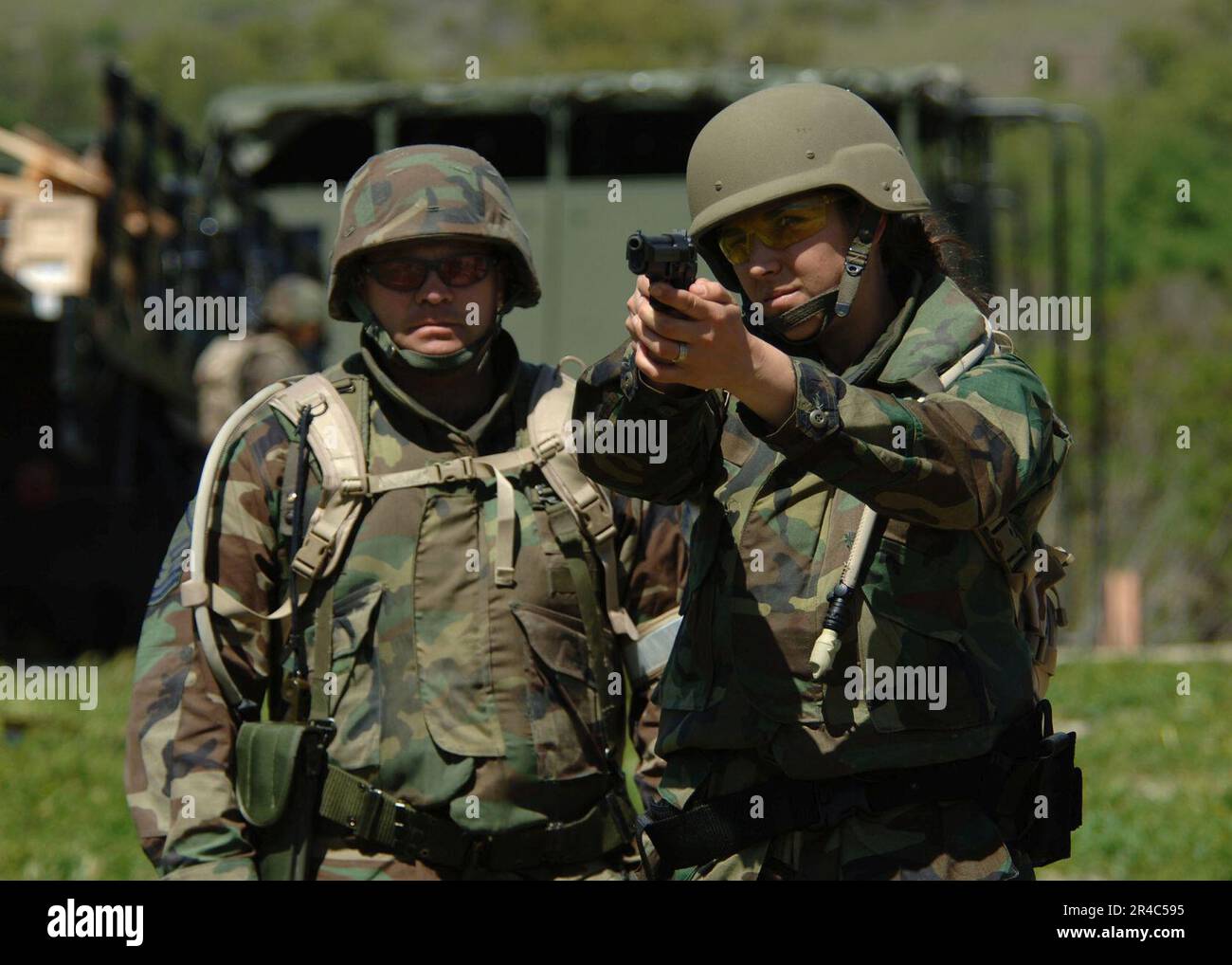 US Navy U.S. Navy Journalist 2nd Class practices her aim, while U.S ...