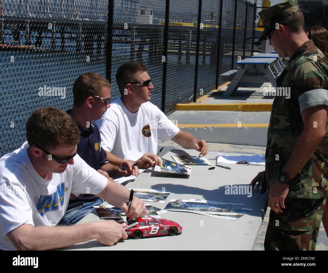 US Navy NASCAR racers Dale Earnhardt Jr., Shane Huffman, and Mark ...