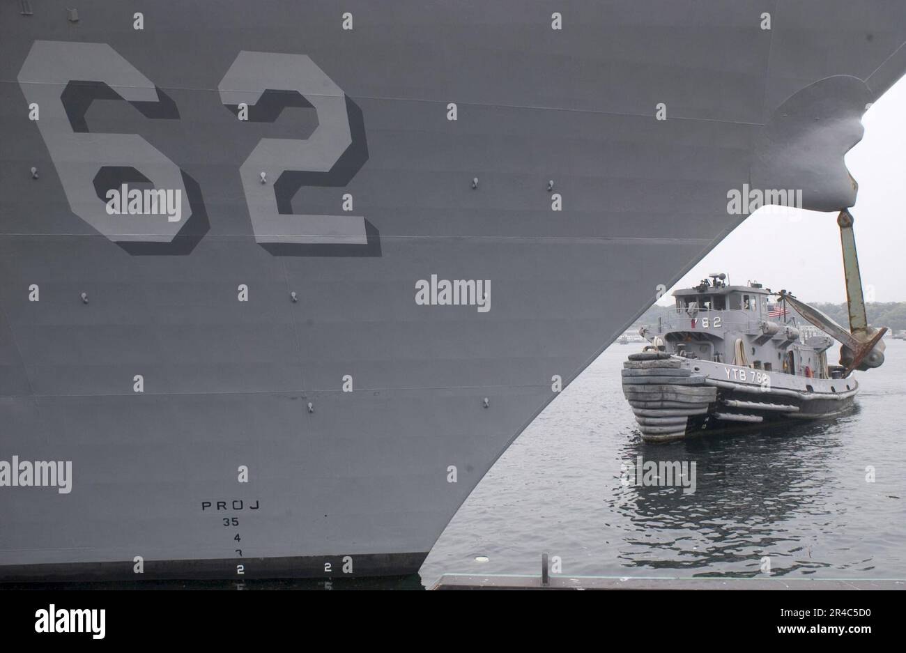 US Navy Large harbor tug USS Manistee (YBT 782) approaches the guided ...