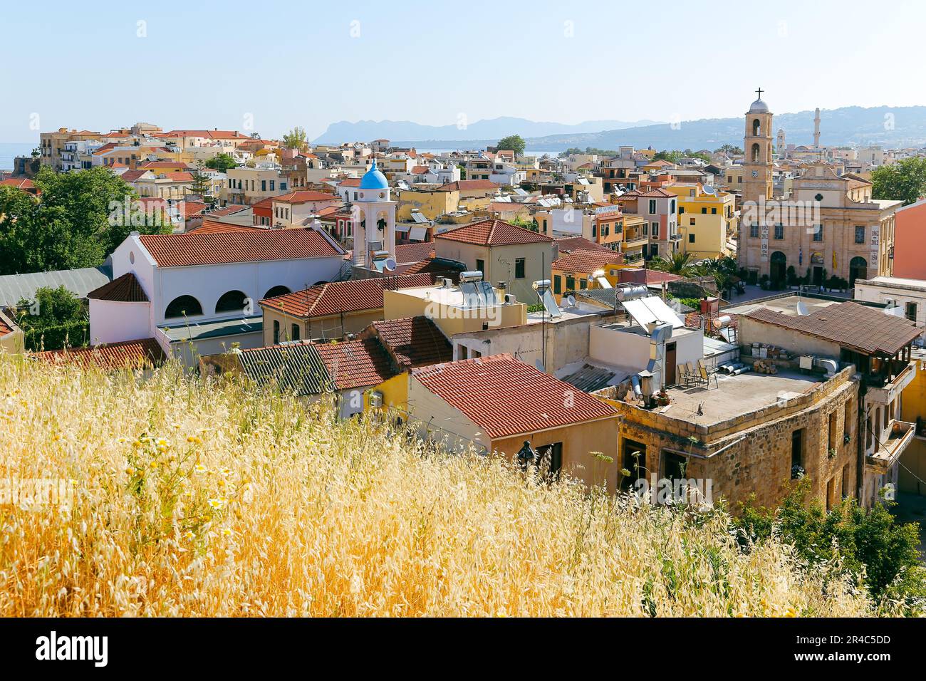 A picturesque small town landscape featuring tall buildings amidst tall ...