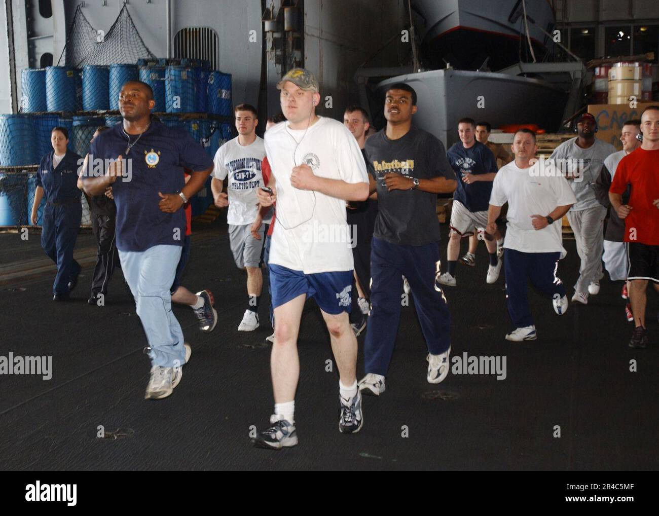 US Navy Sailors aboard USS Theodore Roosevelt (CVN 71) run laps around ...