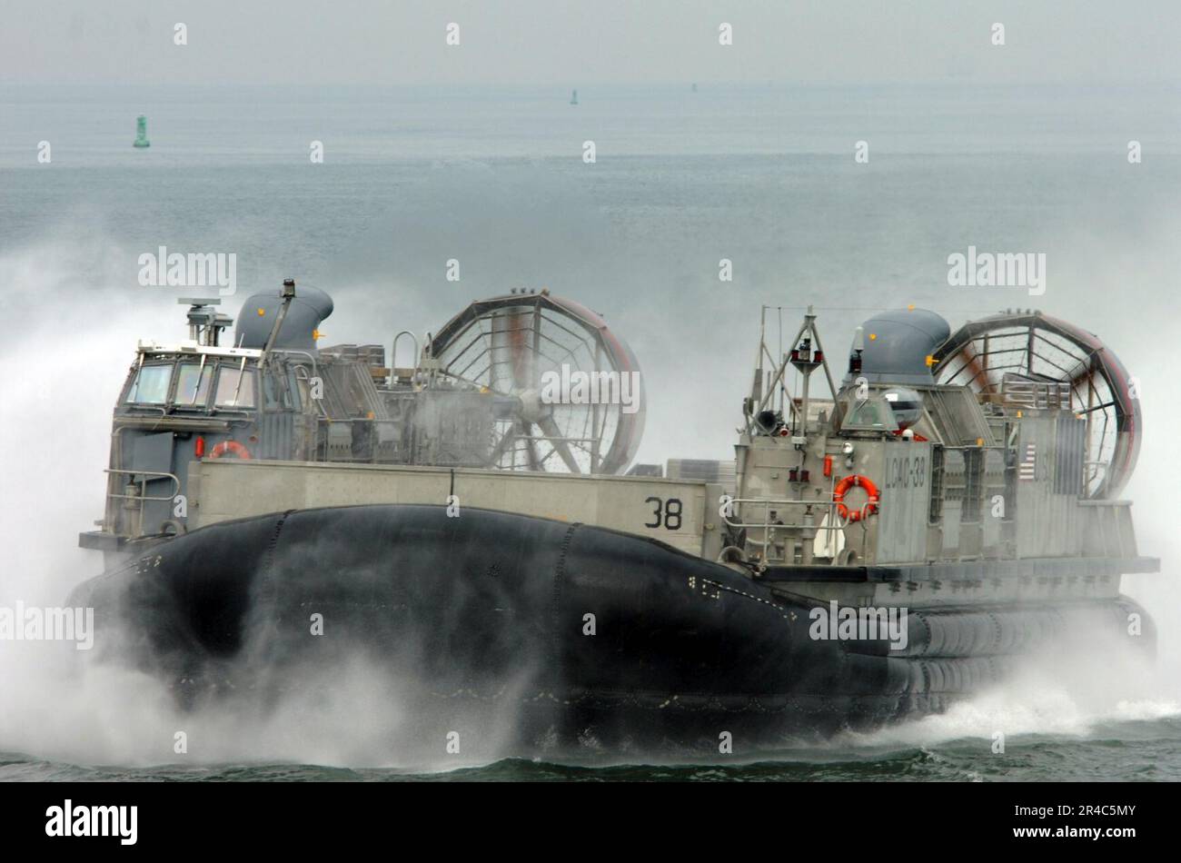 US Navy A Landing Craft Air Cushion (LCAC) speeds around the amphibious ...