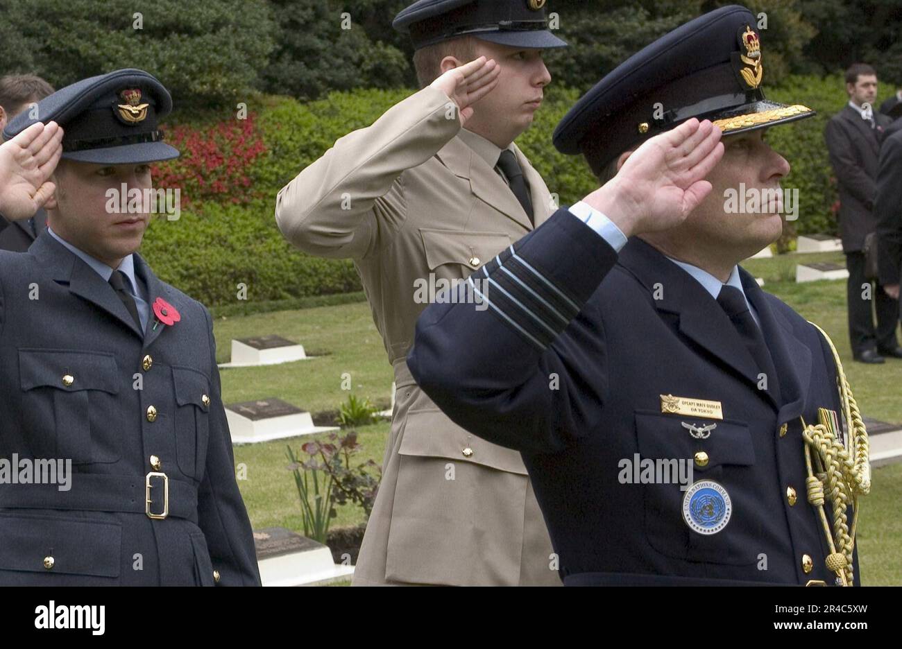 US Navy Guests salute as Last Post is sounded by a bugler during a ...