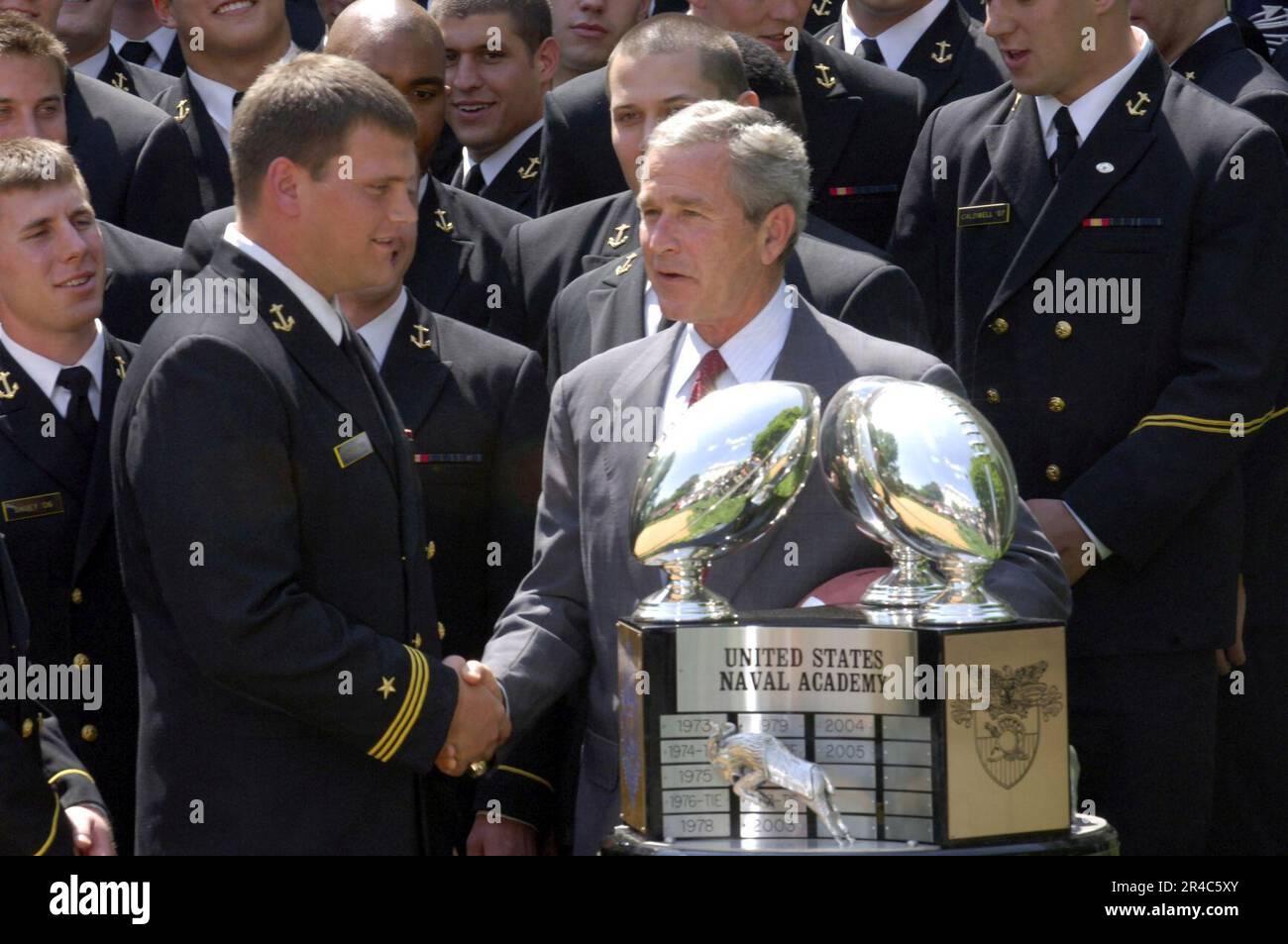 US Navy President George W. Bush congratulates a player of the Navy ...