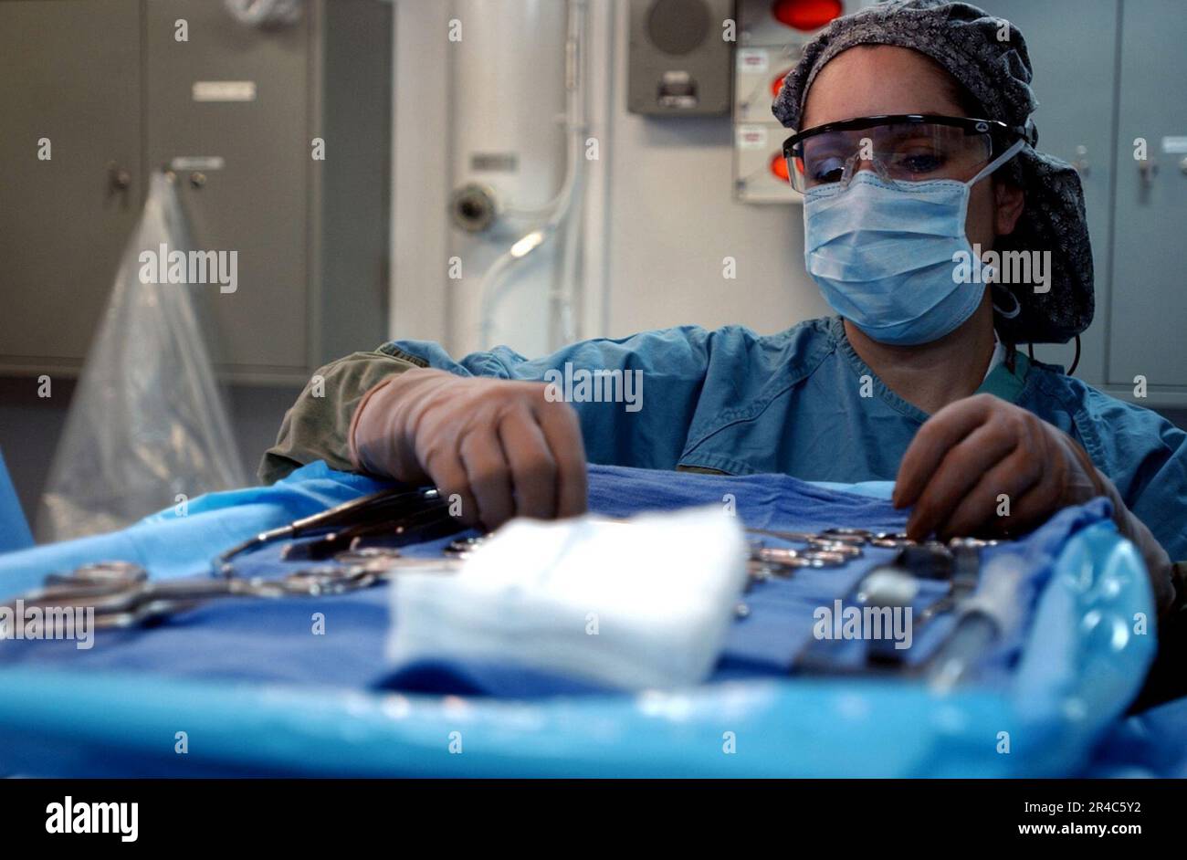 US Navy Hospital Corpsman 1st Class prepares surgical tools before an ...