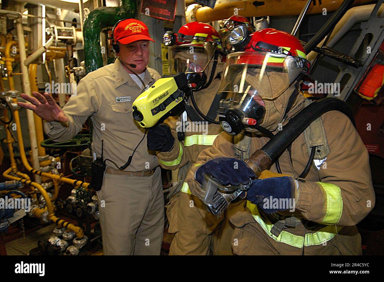 US Navy Chief Machinery Repairman conducts training with a firefighting ...