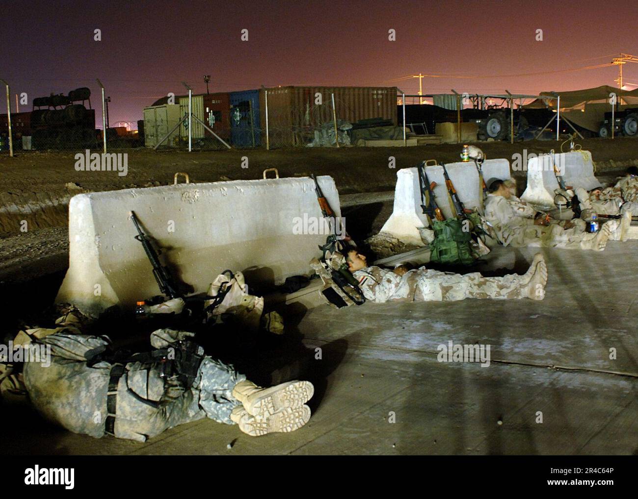 US Navy U.S. Army and Iraqi army soldiers rest on the tarmac at Camp ...
