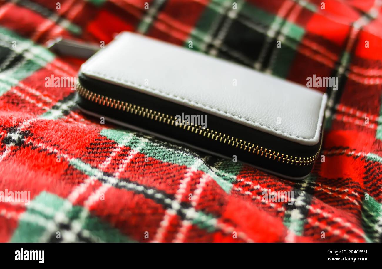 Purple leather wallet on checkered plaid background Stock Photo - Alamy