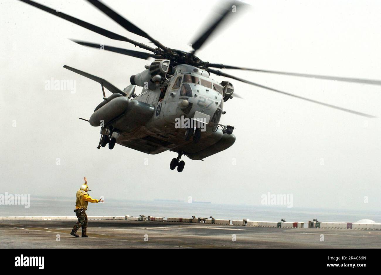 US Navy A CH-53 Super Stallion helicopter takes off from the flight deck aboard the amphibious ...