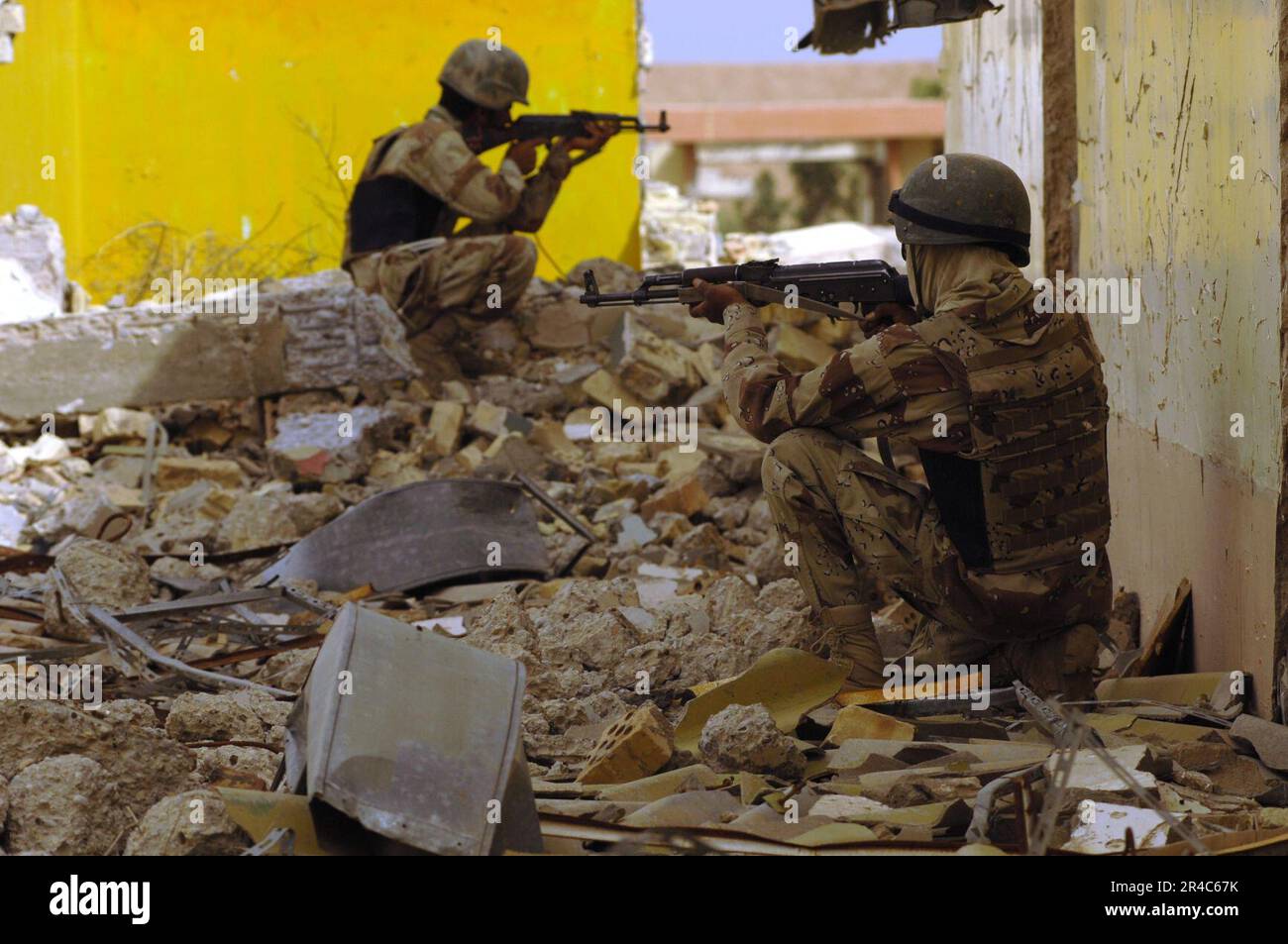 US Navy Two Iraqi Army soldiers post security during a building ...