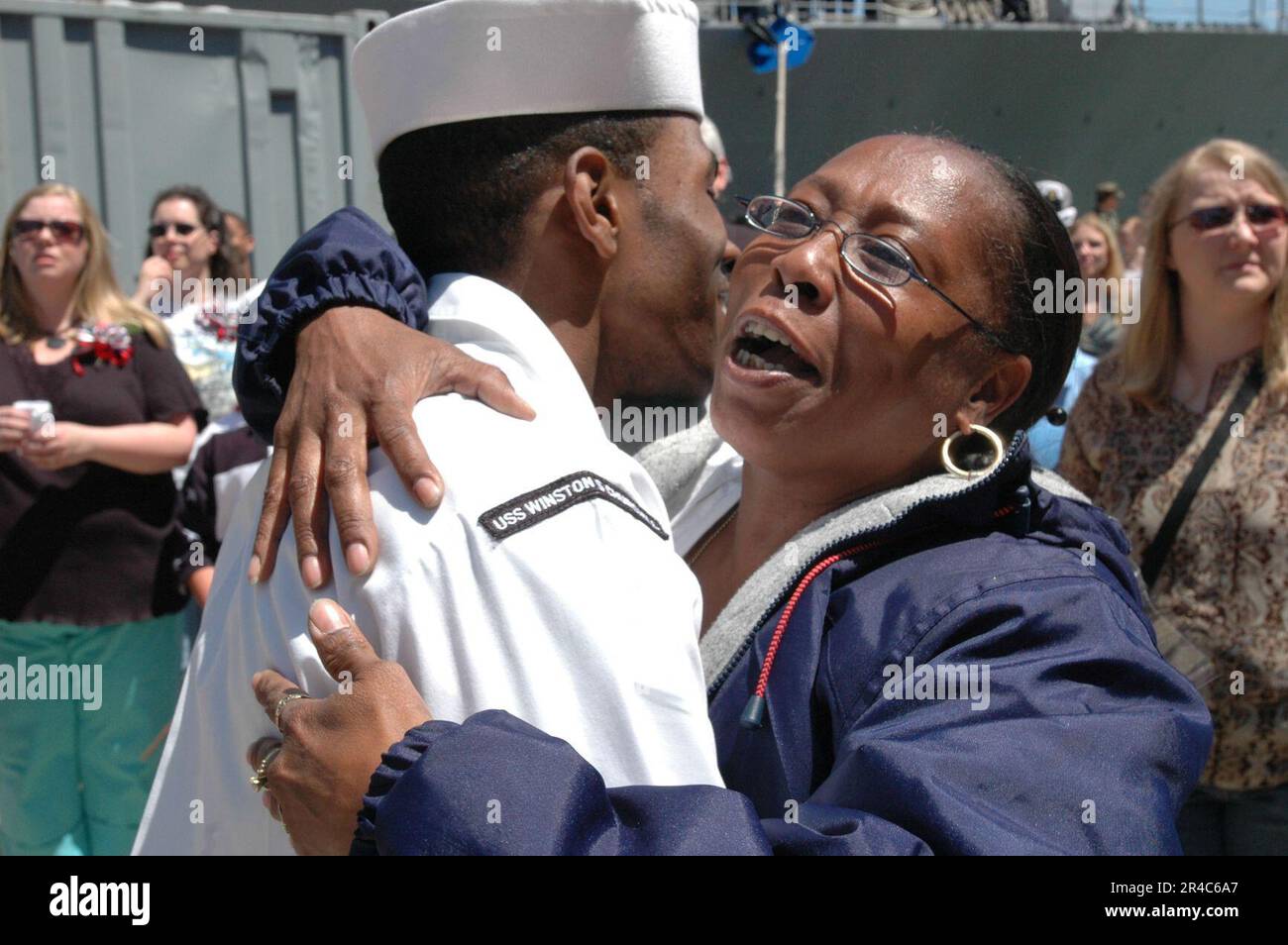 US Navy Family members welcome home the Sailors of the guided missile ...