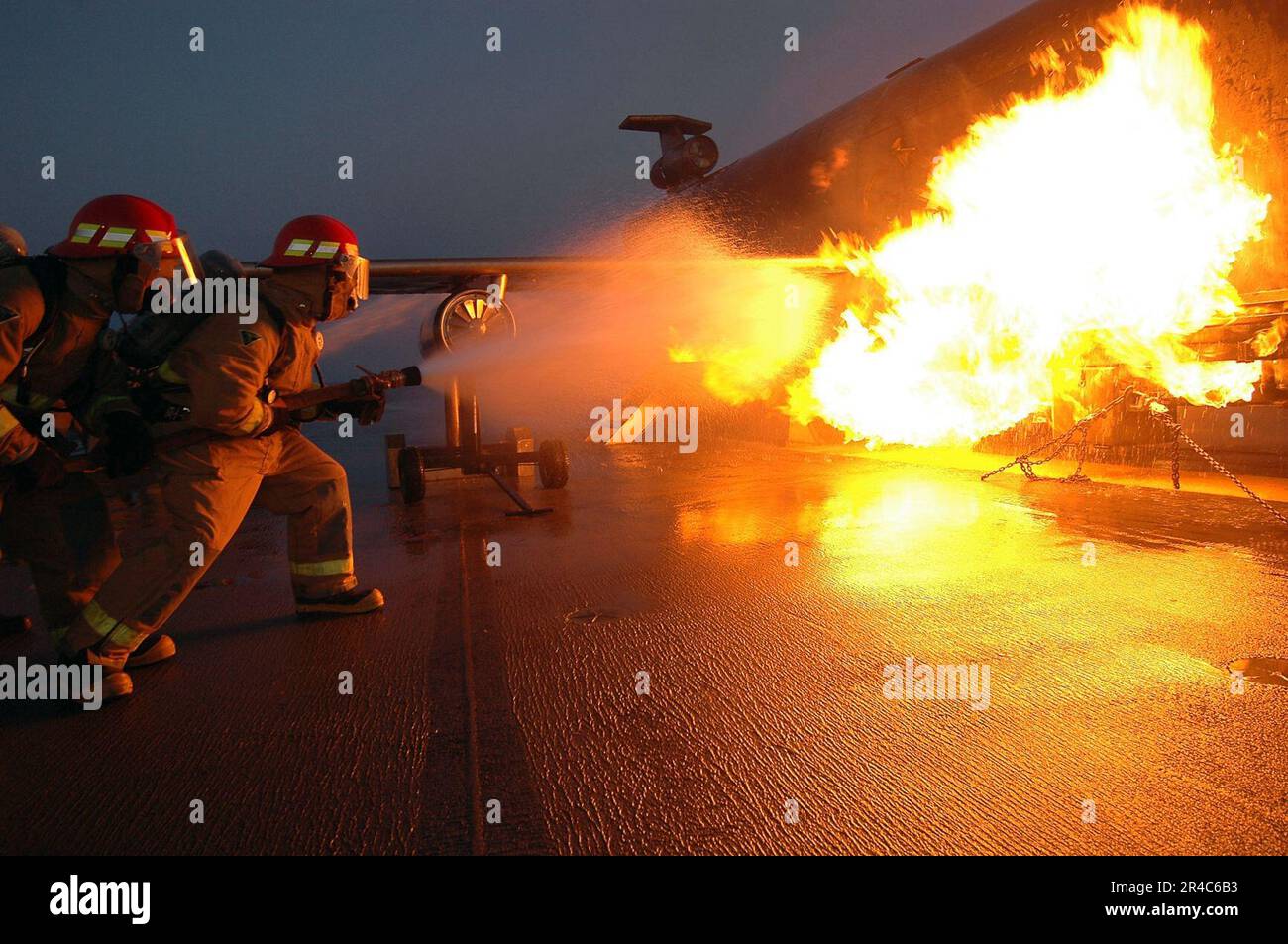 US Navy A hose team assigned to a ship's repair locker combats a ...