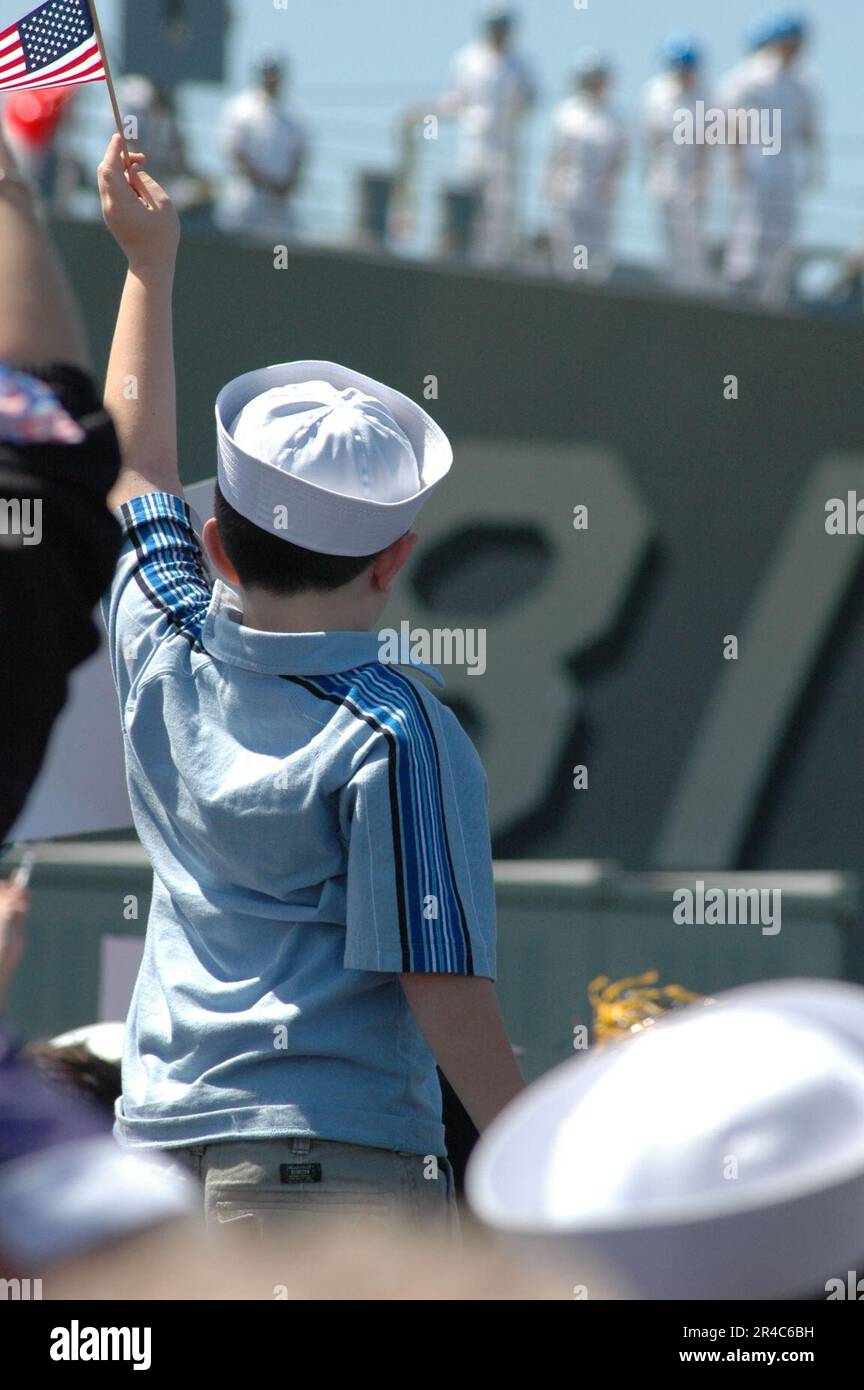 US Navy Family members welcome home the Sailors of the guided missile ...