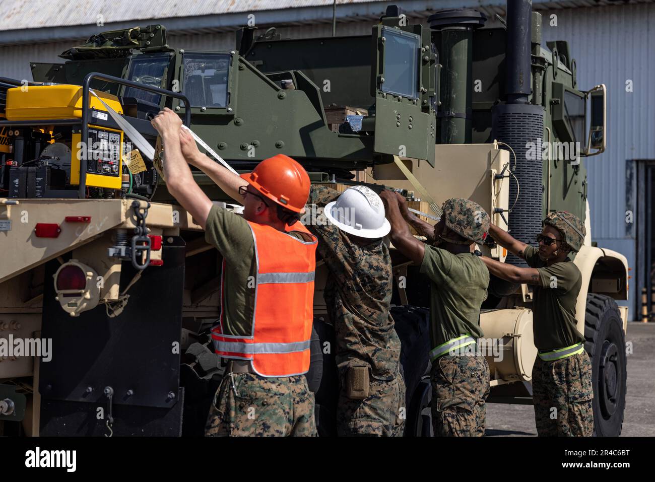 U.S. Marines with 3rd Landing Support Battalion undo loaded equipment ...