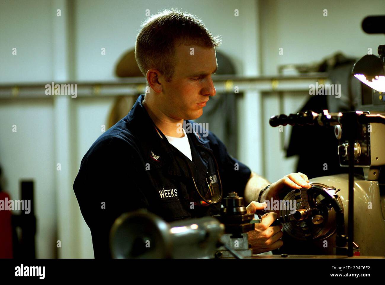 US Navy Machinery Repairman 3rd Class drills threading into a metal ...