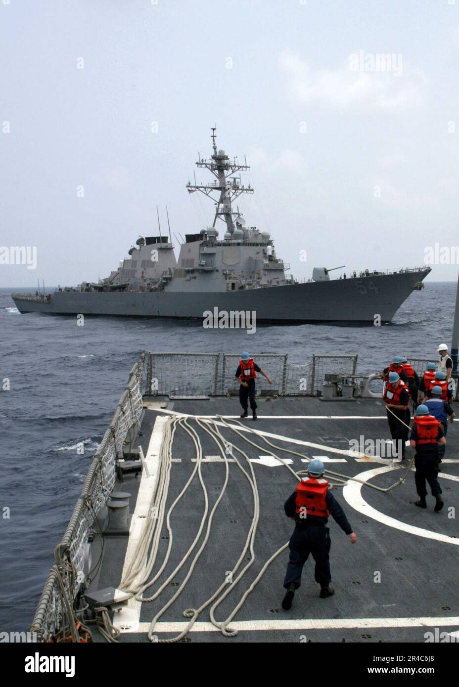 US Navy Boatswain's mates heave lines as the guided-missile destroyer ...