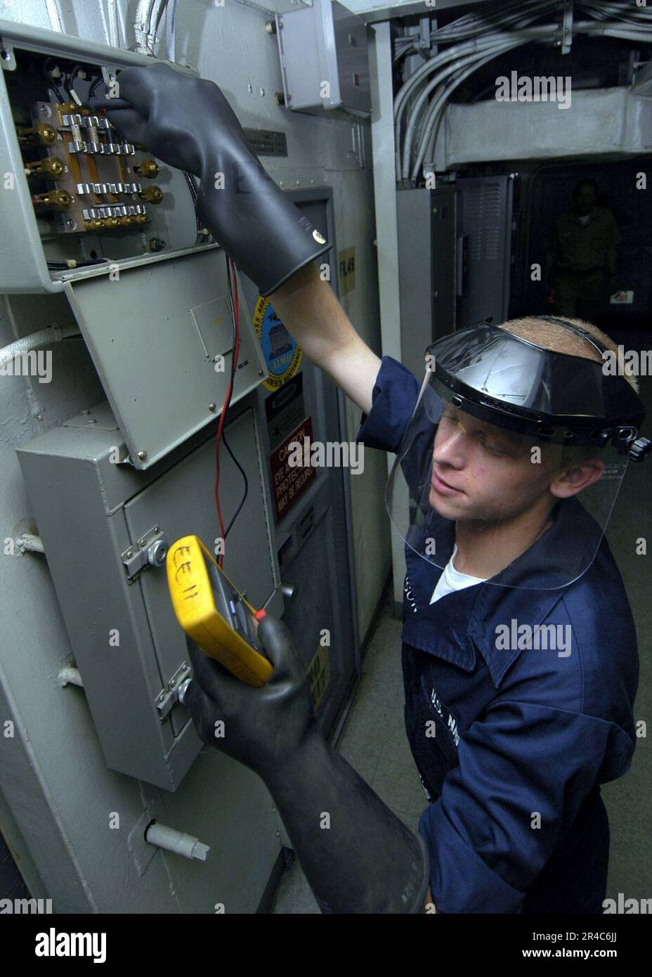 US Navy Electricians Mate Fireman changes a fuse in a distribution box ...