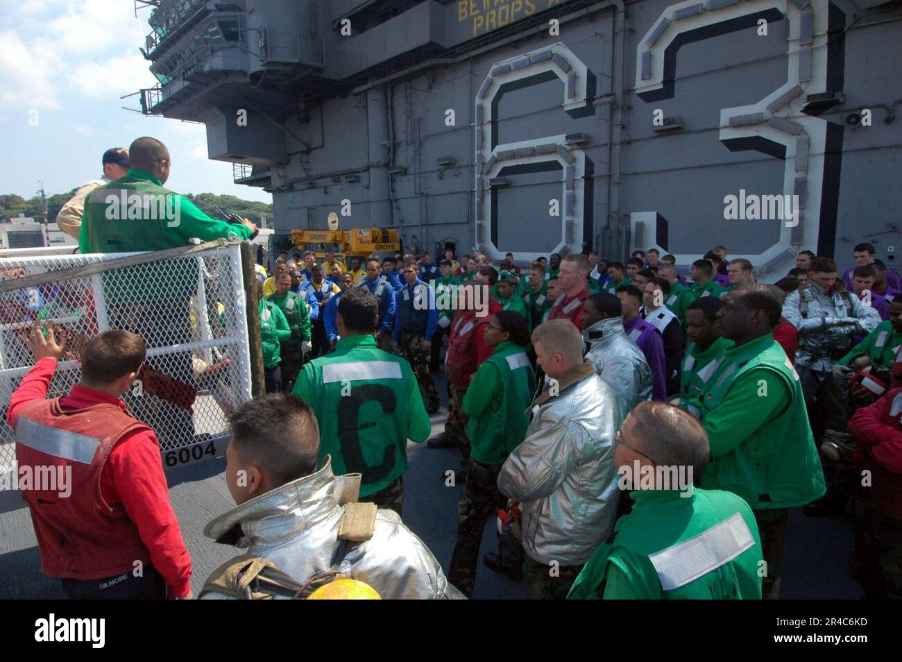 US Navy Air department Sailors listen to a safety brief prior to an ...