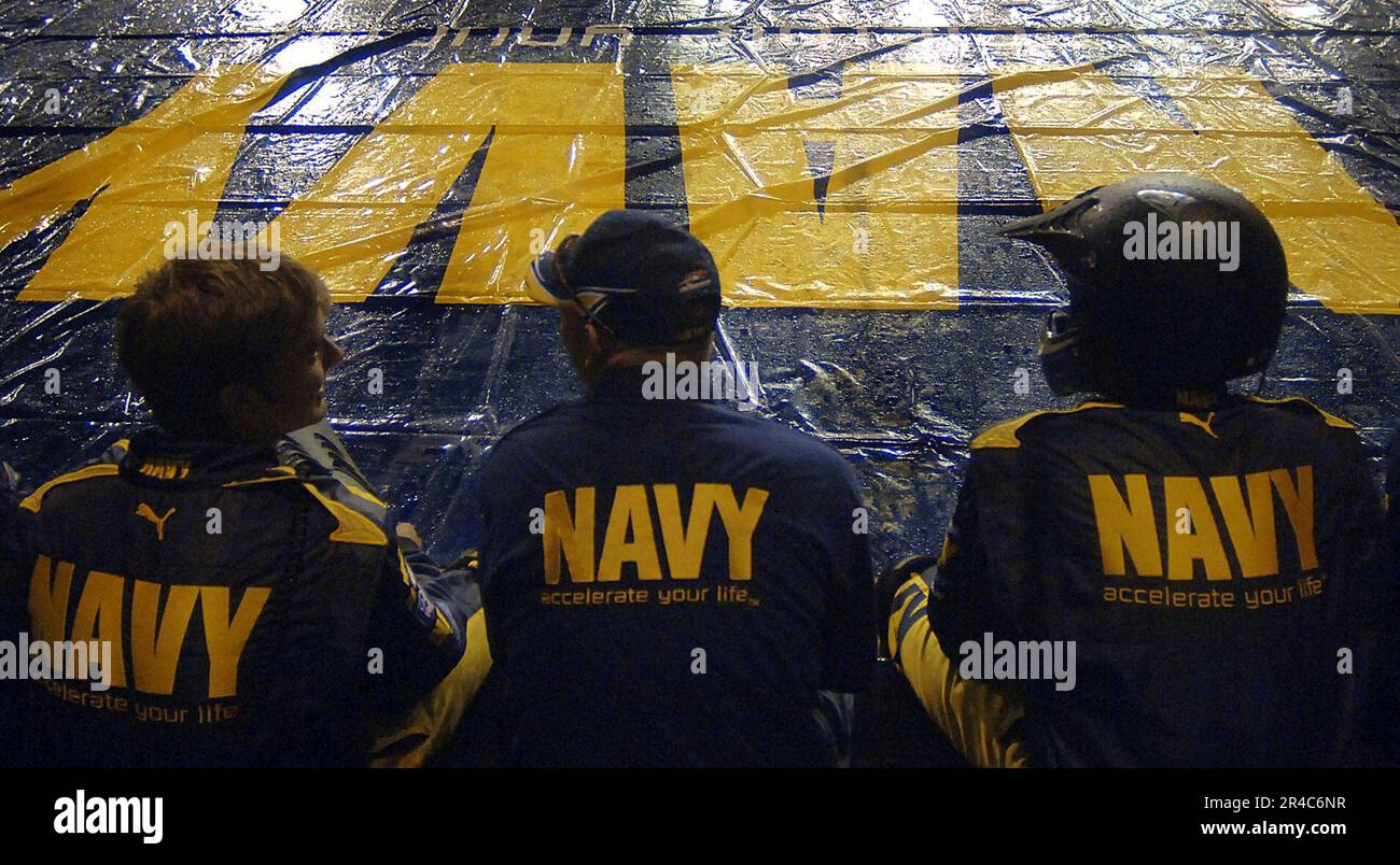 US Navy Members of the No. 88 Navy Accelerate Your Life pit crew wait ...